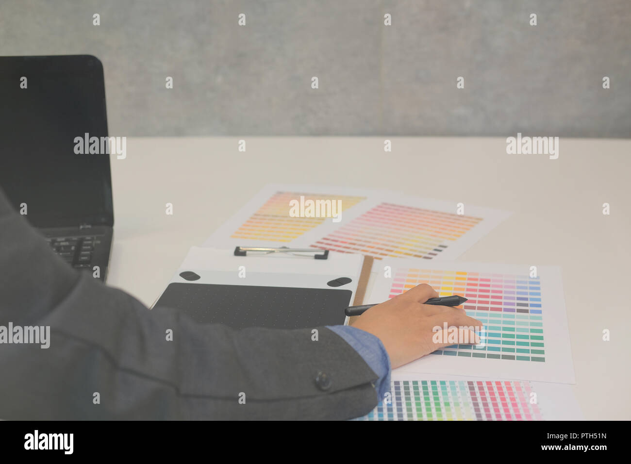 graphic interior designer choosing color from swatch sample catalogue ...