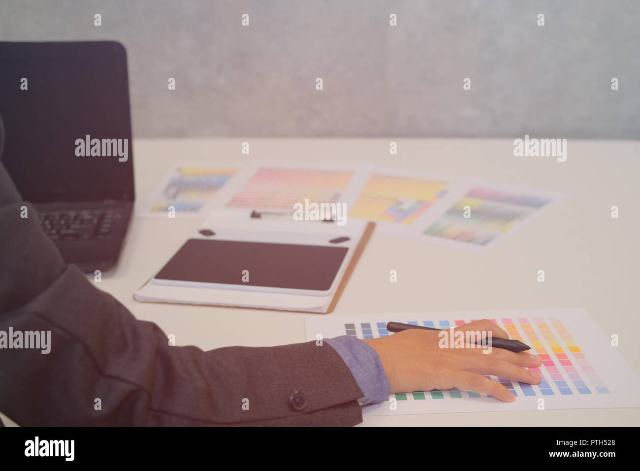 graphic interior designer choosing color from swatch sample catalogue ...