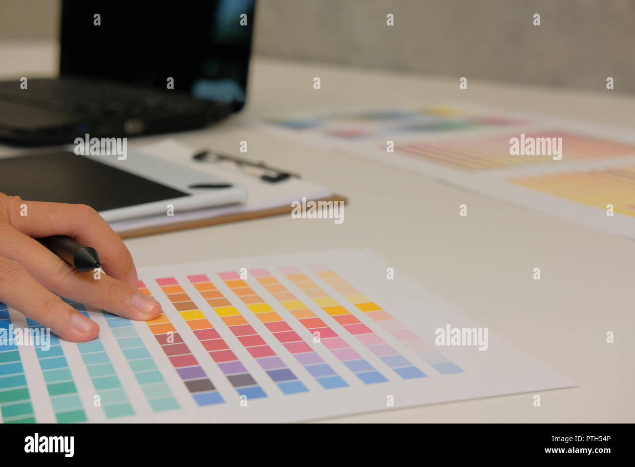 graphic interior designer choosing color from swatch sample catalogue ...