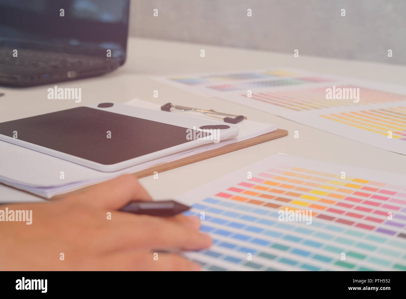 graphic interior designer choosing color from swatch sample catalogue ...