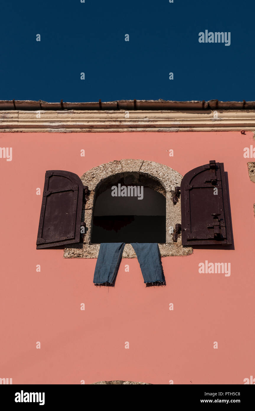 Bosnia: a window with iron shutters and pants hanging out to dry in the ...