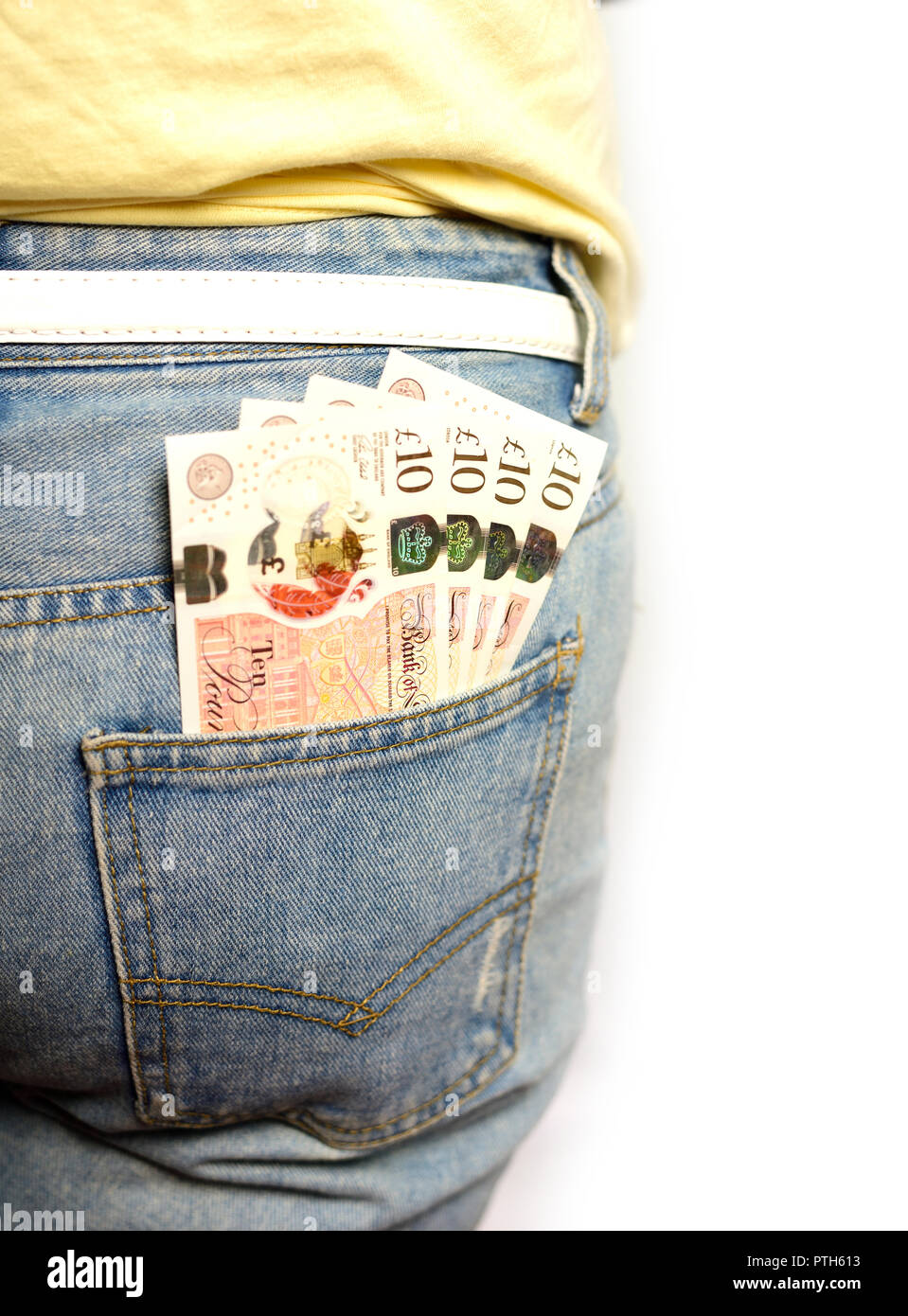 Pound currency note in rear pocket on white background Stock Photo - Alamy