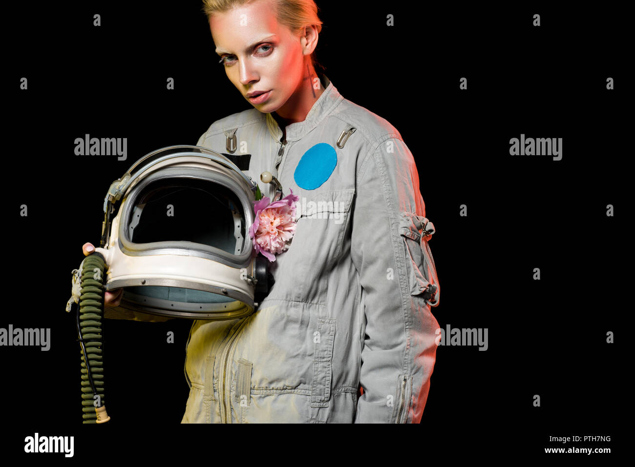 beautiful female cosmonaut in spacesuit holding helmet and flower ...