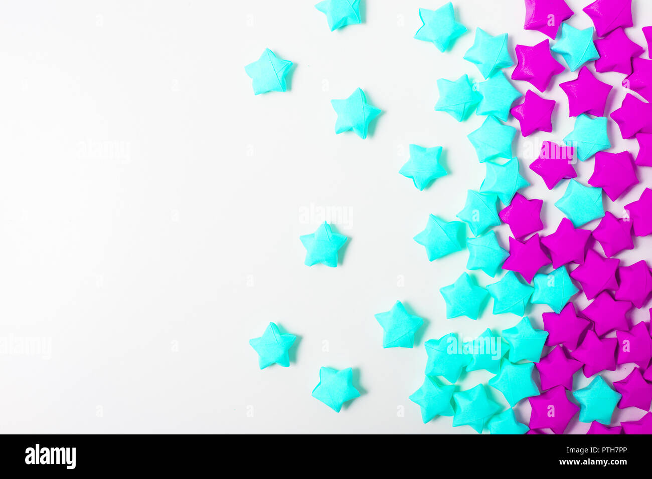 Two colored stars of paper on the white background with copy space ...