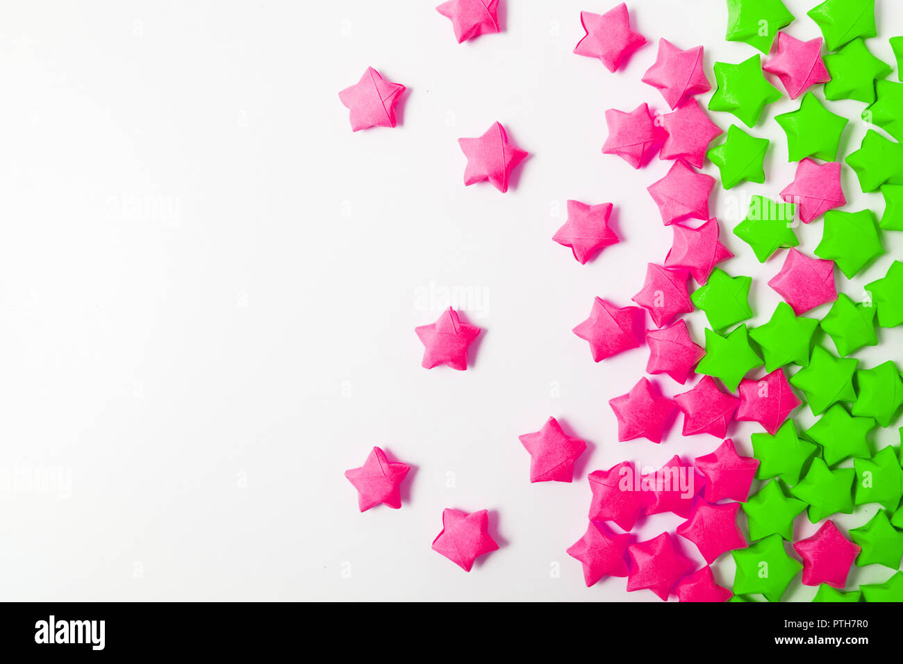 Two colored stars of paper on the white background with copy space ...