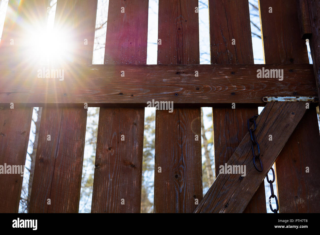 Sunlight through wooden gate in spring Stock Photo - Alamy