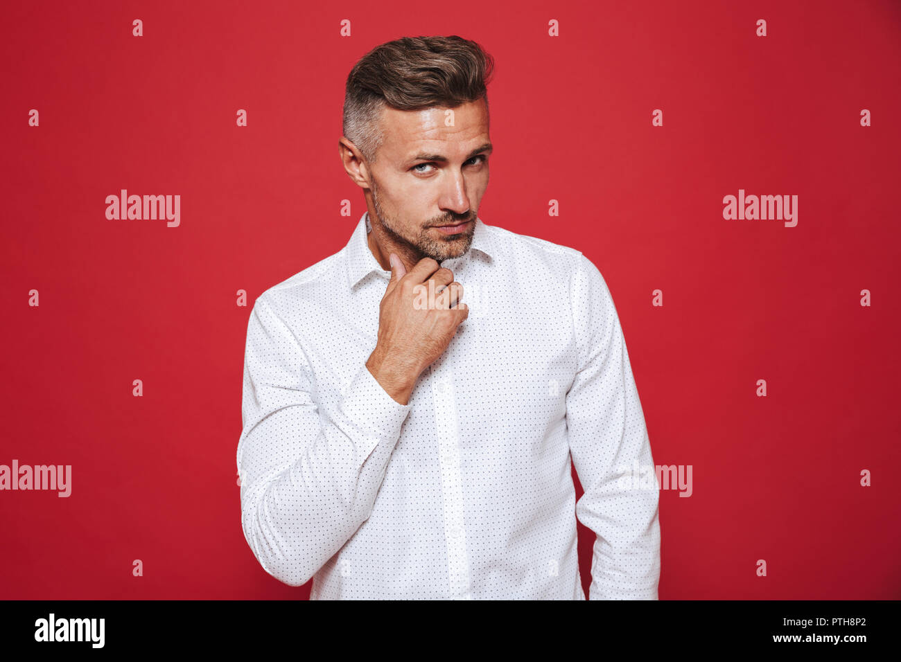 European guy with stubble in white shirt looking aside isolated over ...