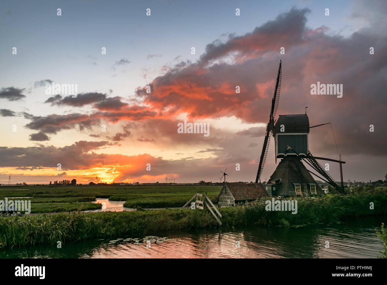 Classic Windmill in the dutch polder landscape at Sunset Stock Photo ...