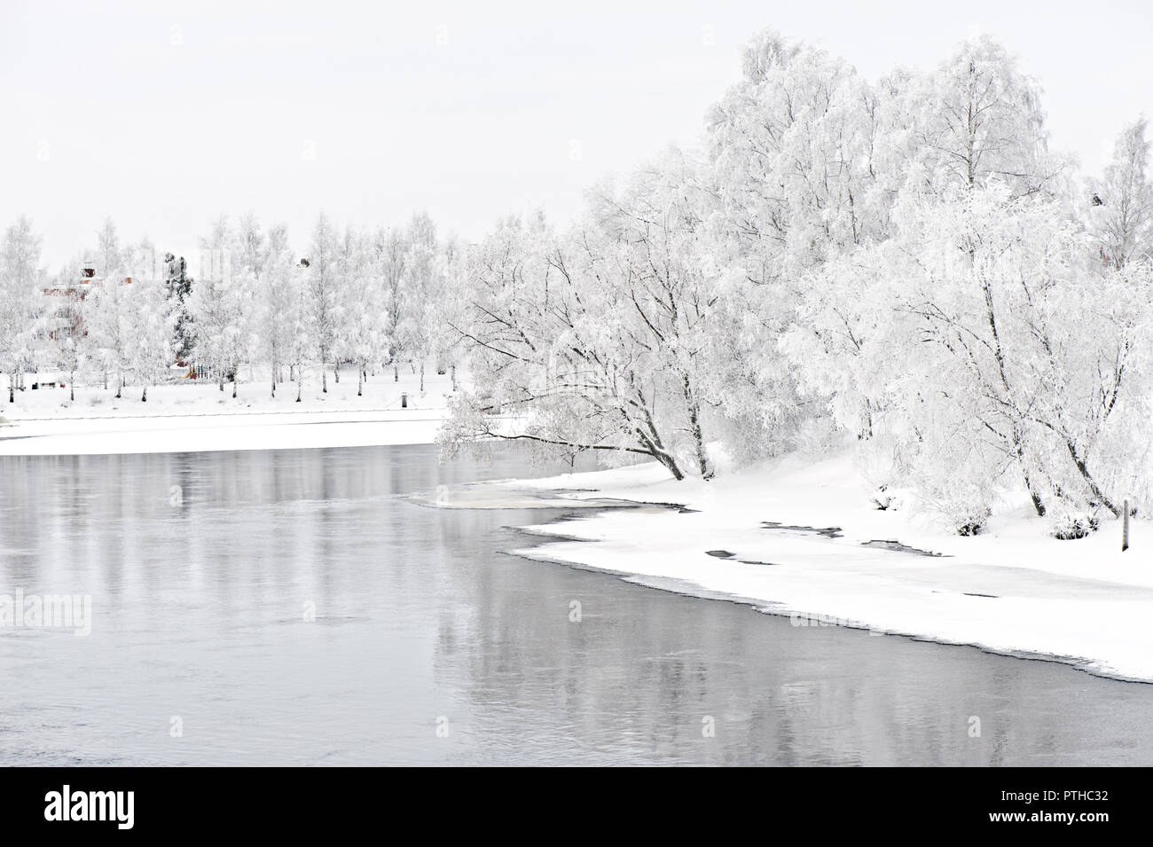 Winter river scenery with frost covered trees on riverbank Stock Photo ...