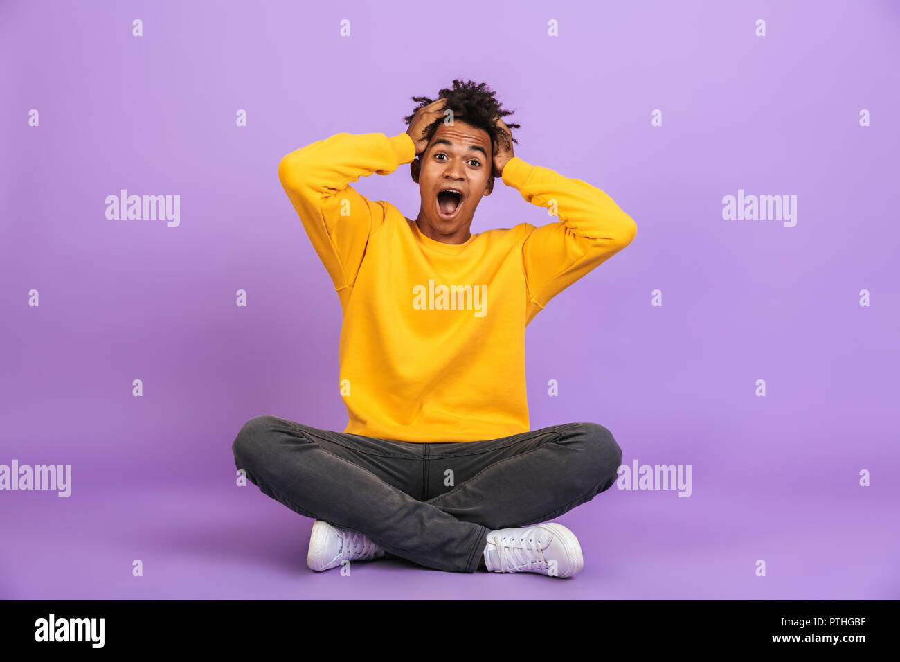 Portrait of excited african american boy screaming and grabbing head ...