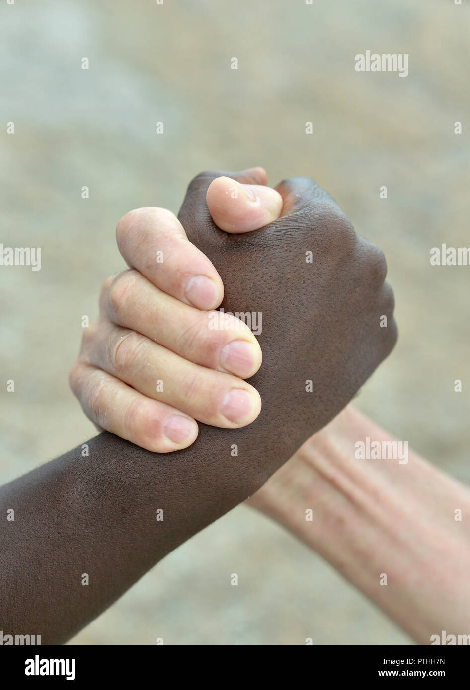 Multi-Ethnic hands in handshake close-up on abstract background Stock ...
