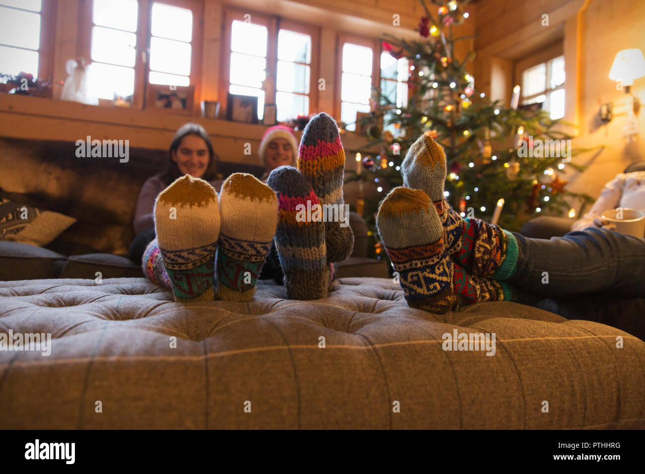 Family with colorful socks relaxing in Christmas living room Stock ...