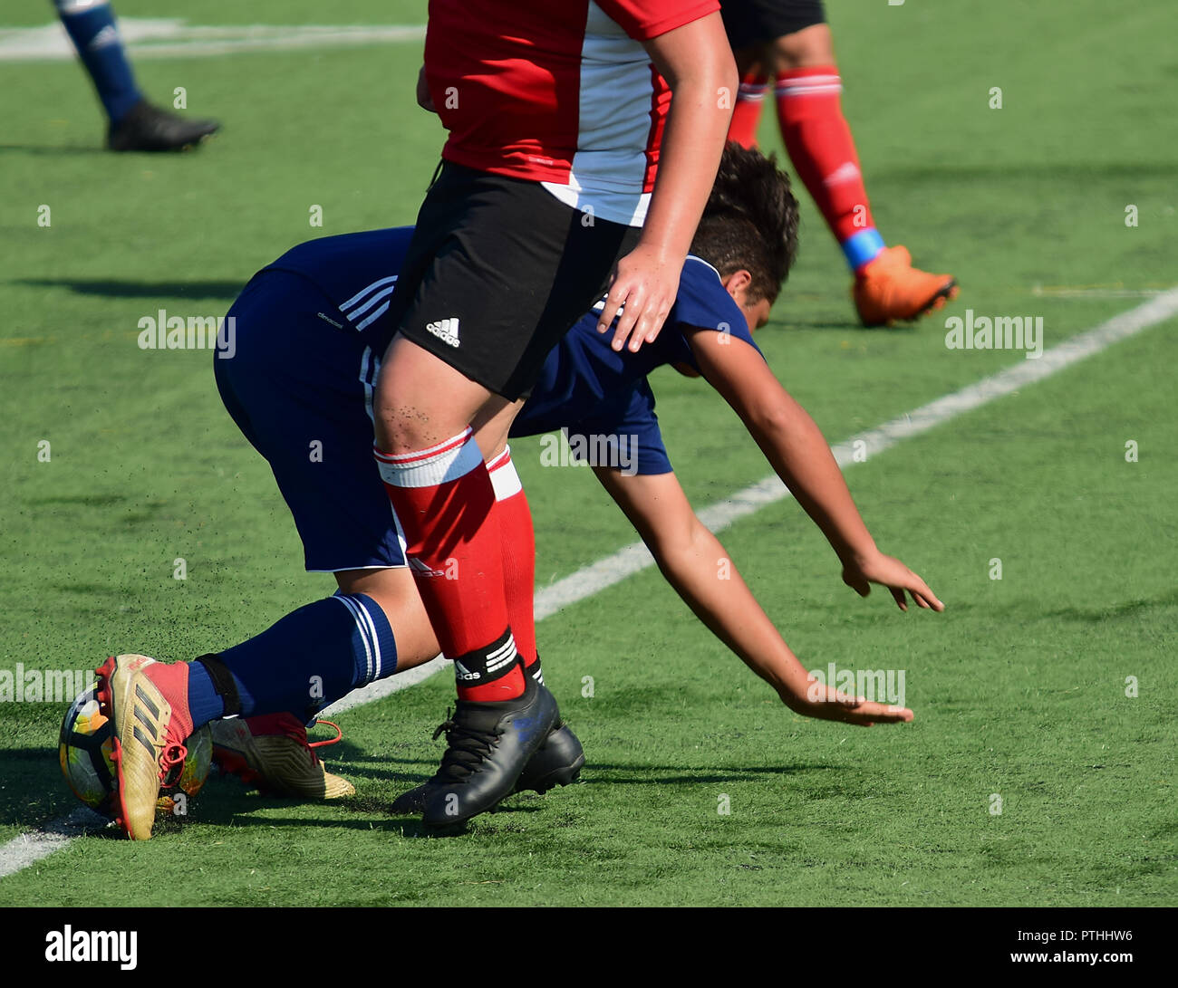 Kid falling playing football hi-res stock photography and images - Alamy