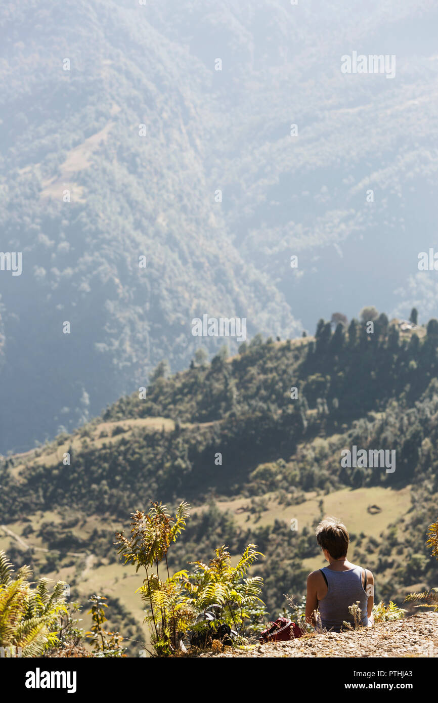 Female hiker resting, enjoying sunny green foothills view, Supi ...