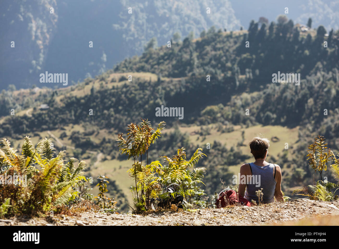 Female hiker resting, enjoying sunny scenic view, Supi Bageshwar ...