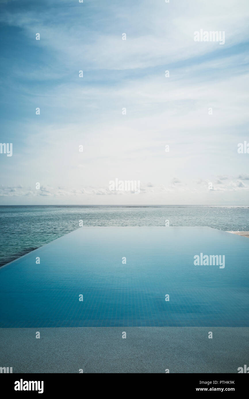 Tranquil blue infinity pool and ocean, Maldives, Indian Ocean Stock ...