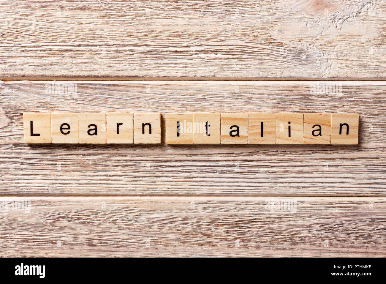 learn italian word written on wood block. learn italian text on table ...