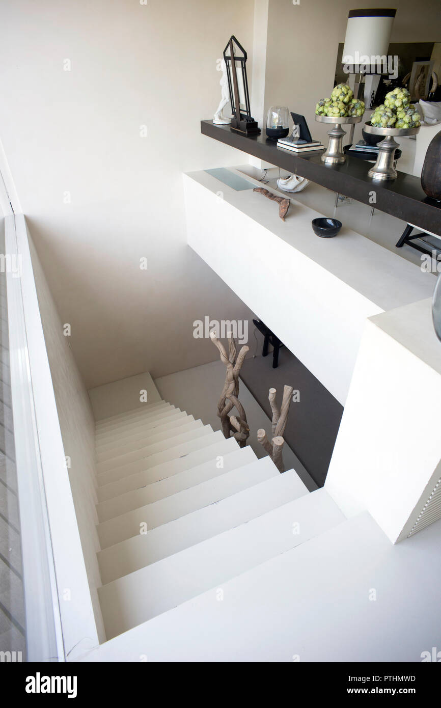 Staircase in an apartment going to a lower level basement Stock Photo ...