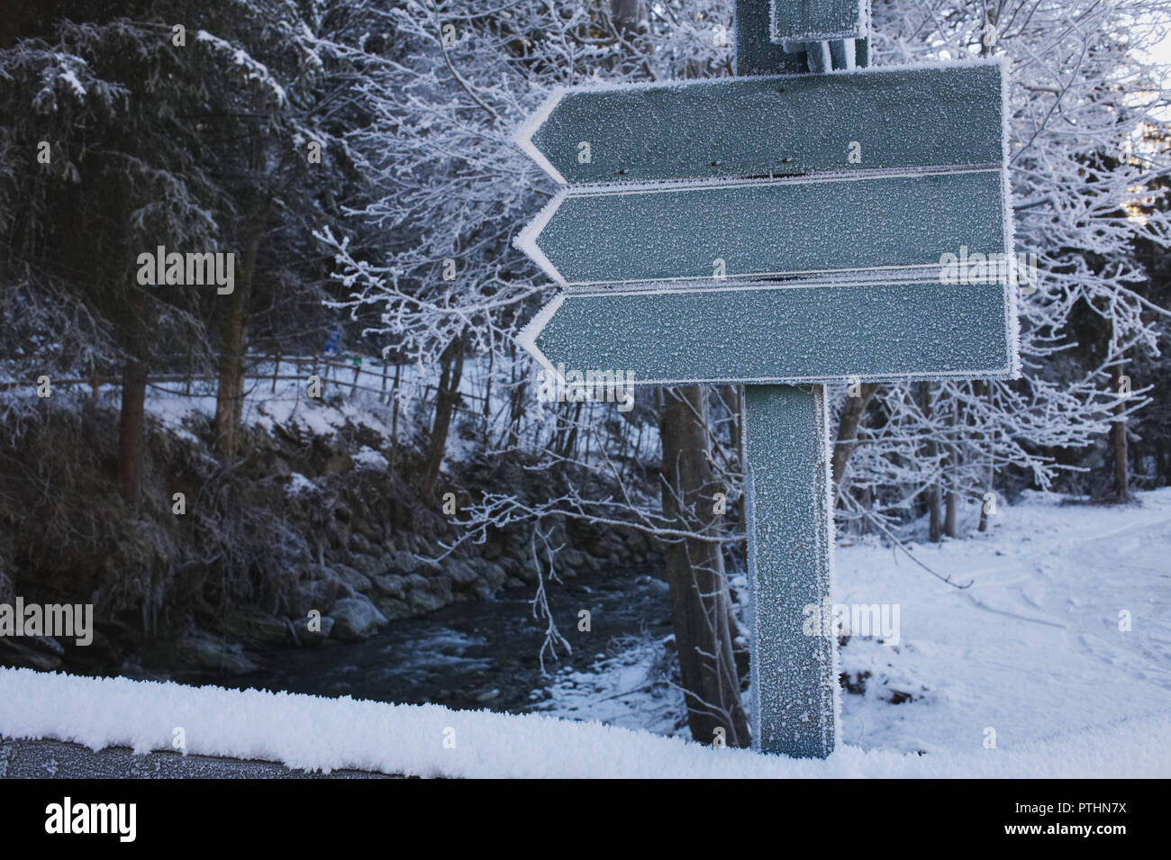 Three arrow signs pointing to the left in a winter landscape Stock ...