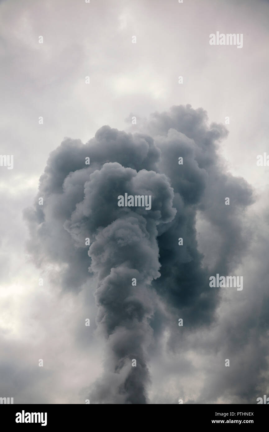 black smoke rising in the sky, environmental pollution Stock Photo - Alamy