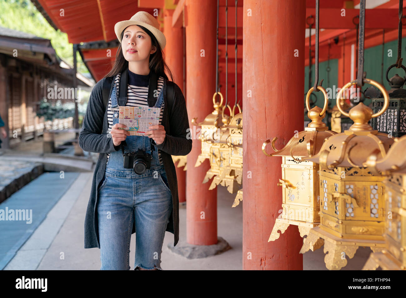 a confident female tourist visiting the temple with her guidebook Stock ...
