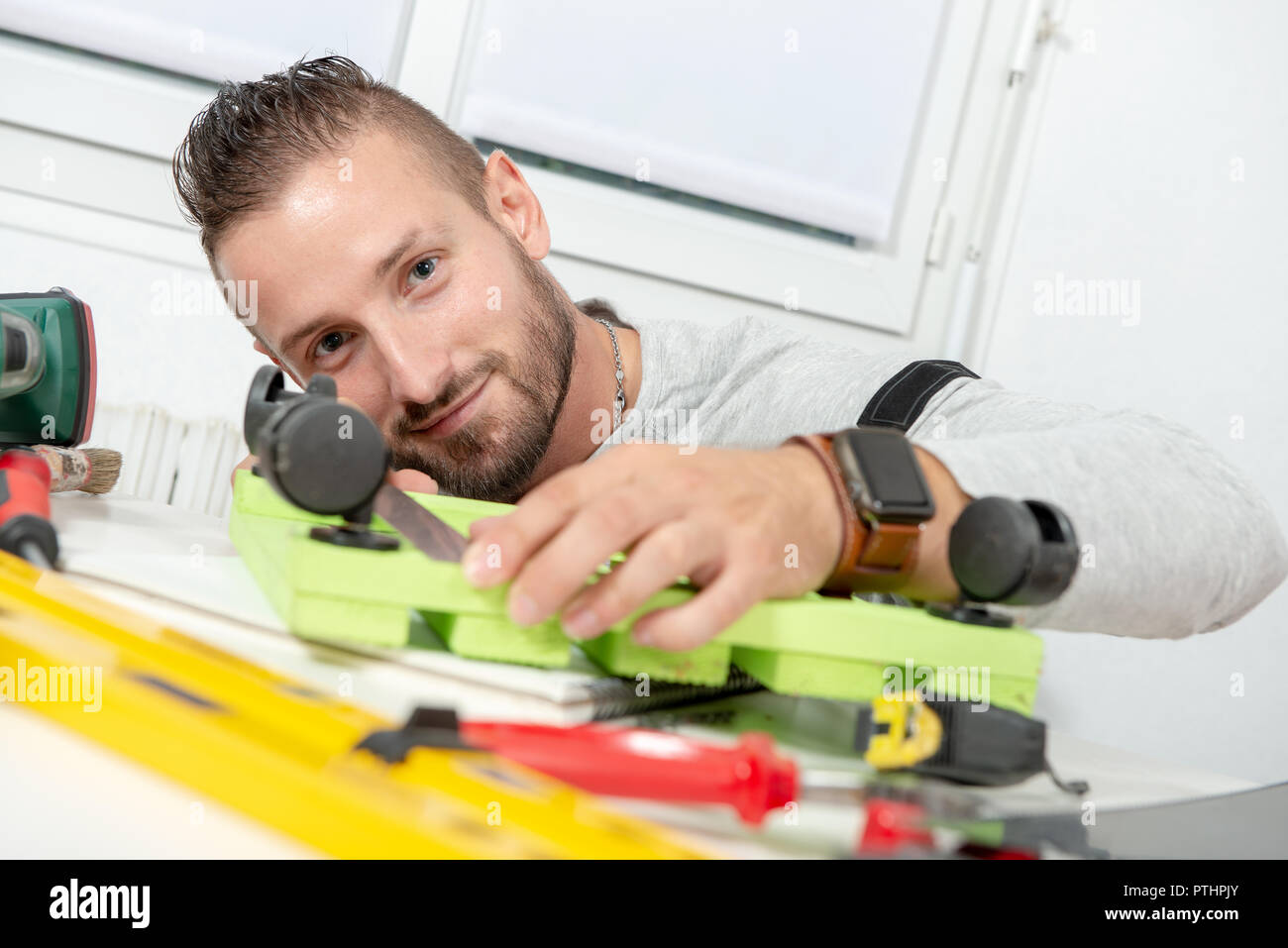 Handyman measuring furniture measuring tape hi-res stock photography ...
