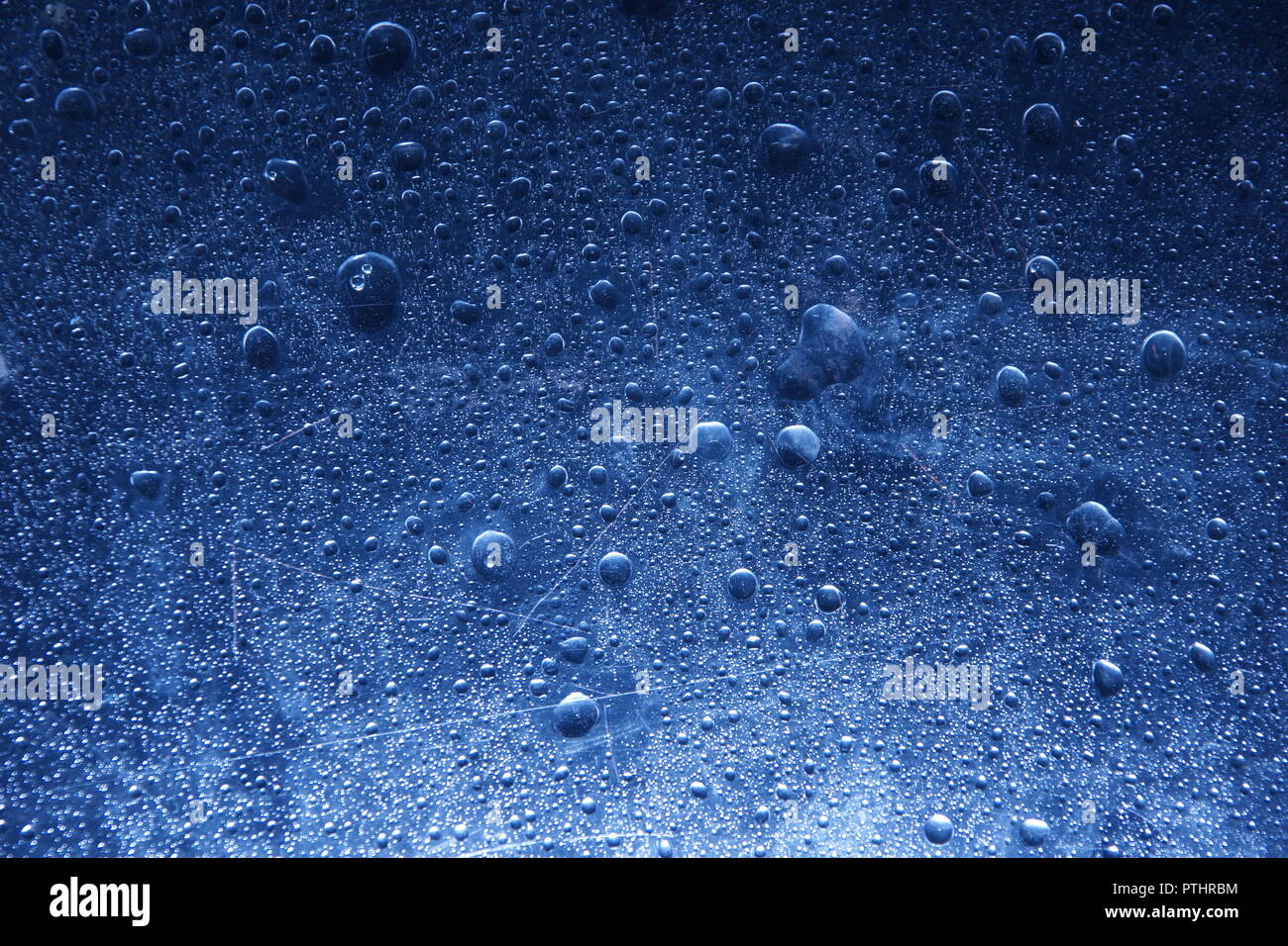 frozen water drops blue background close-up Stock Photo - Alamy