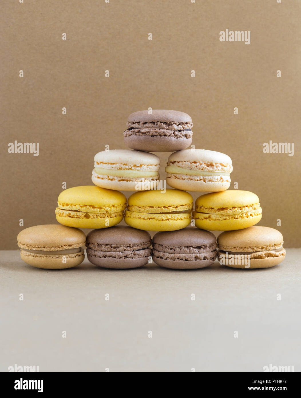 stack of plain colored macaroon in coffee and lemon flavour vertical ...