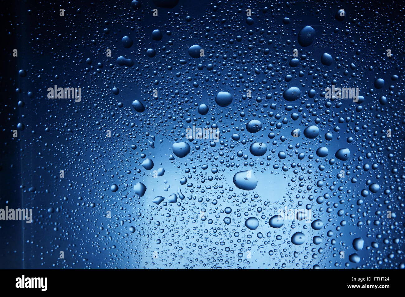 frozen water drops blue background close-up Stock Photo - Alamy