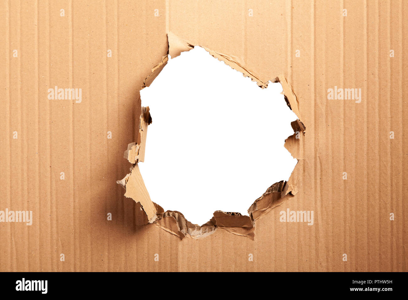 Cardboard with a hole - white background Stock Photo - Alamy