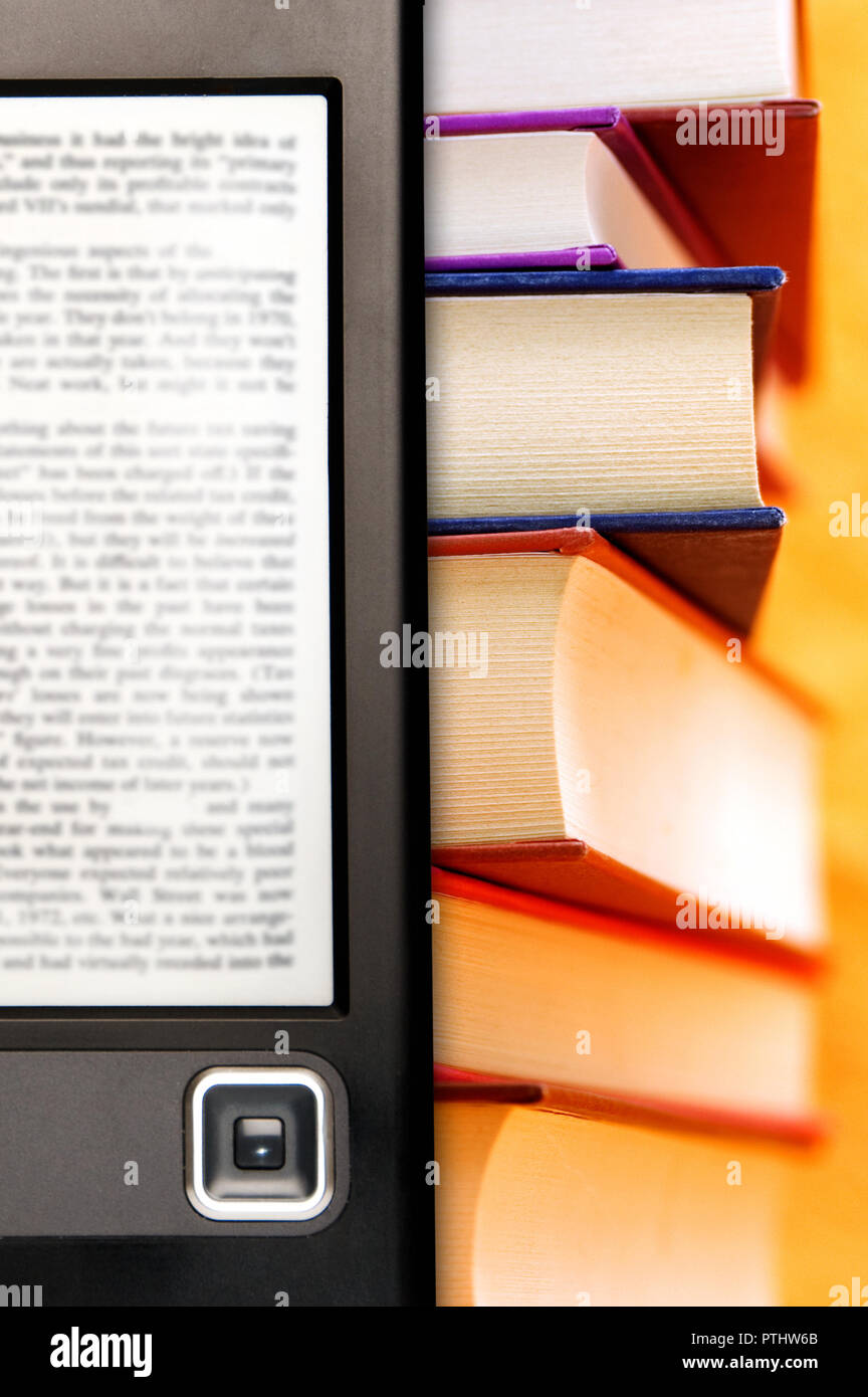 e-book reader and stack of books Stock Photo - Alamy