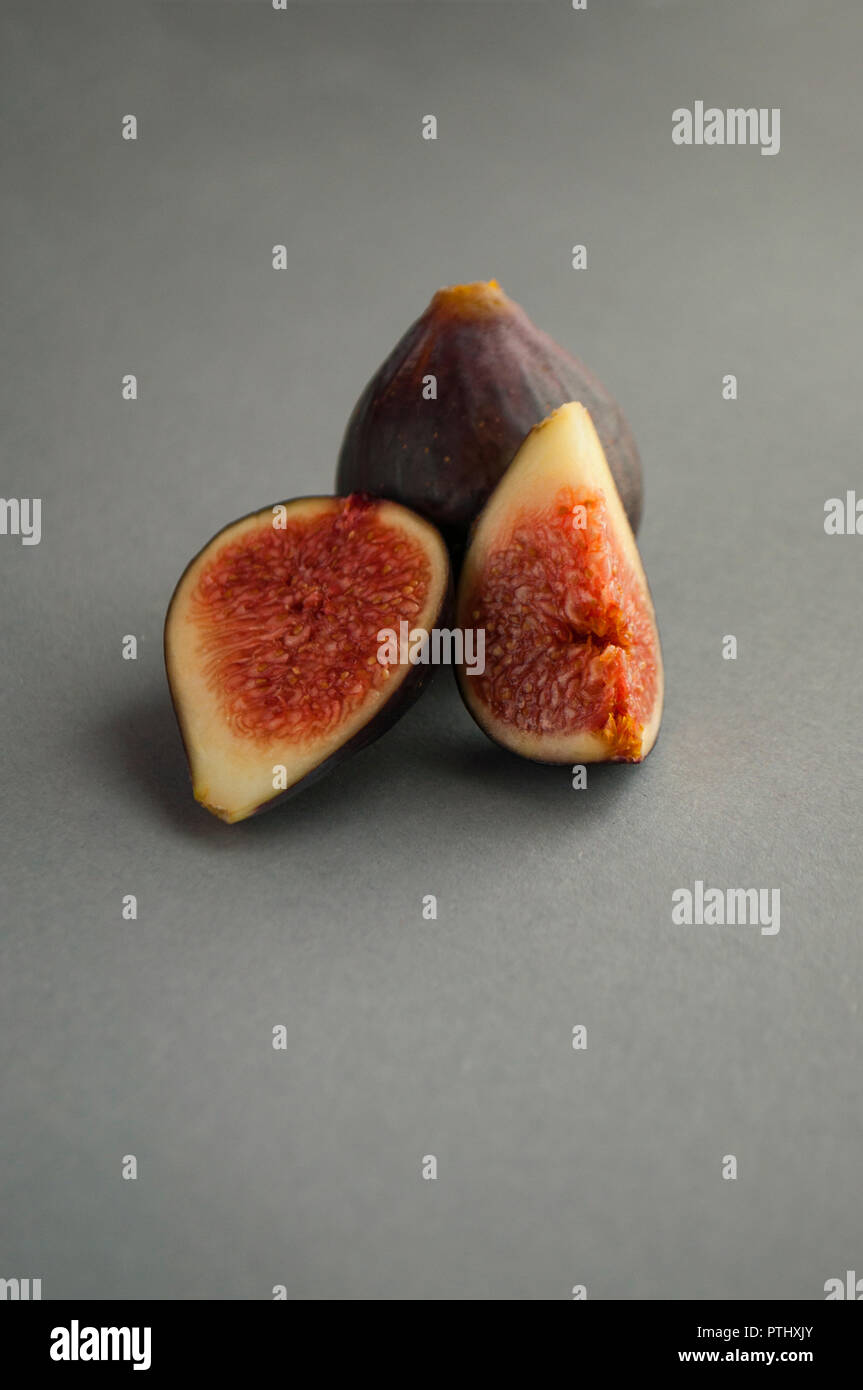 Freshly picked sweet ripe and cut figs on grey background Stock Photo ...