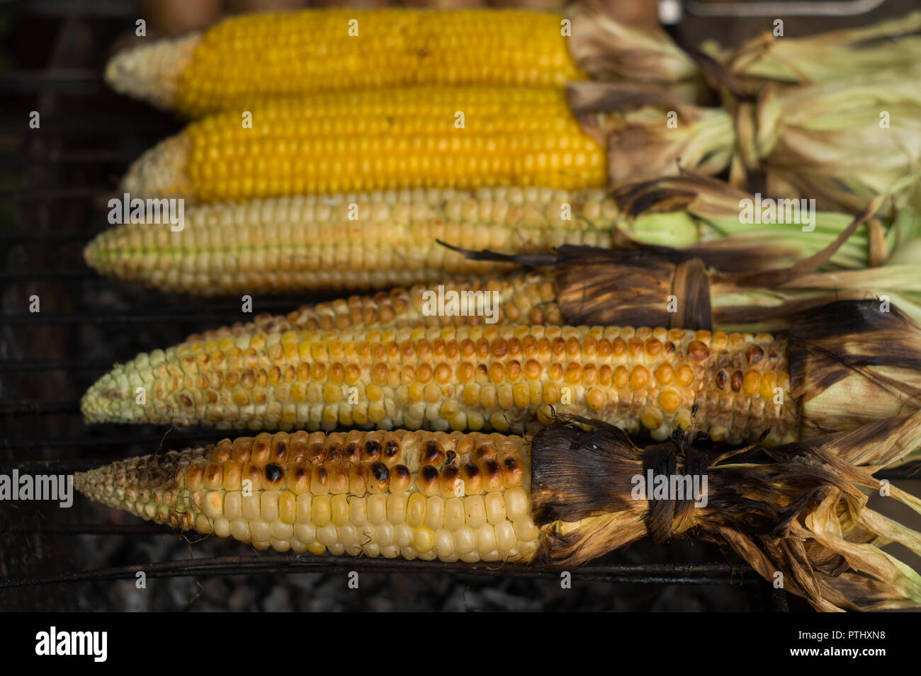 Baked whole corn on the BBQ Stock Photo - Alamy