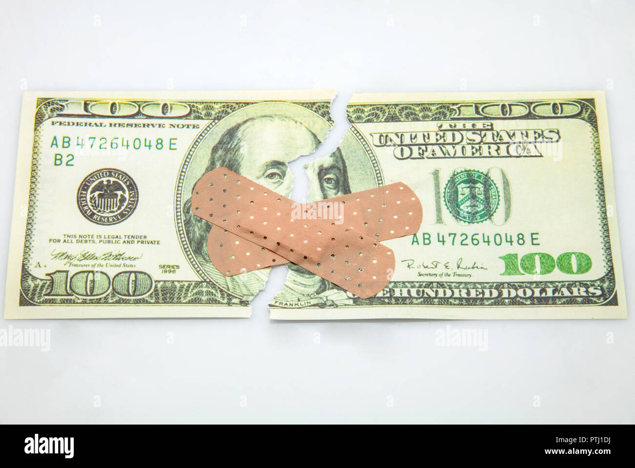 broken ticket for hundred dollars given with a plaster Stock Photo - Alamy