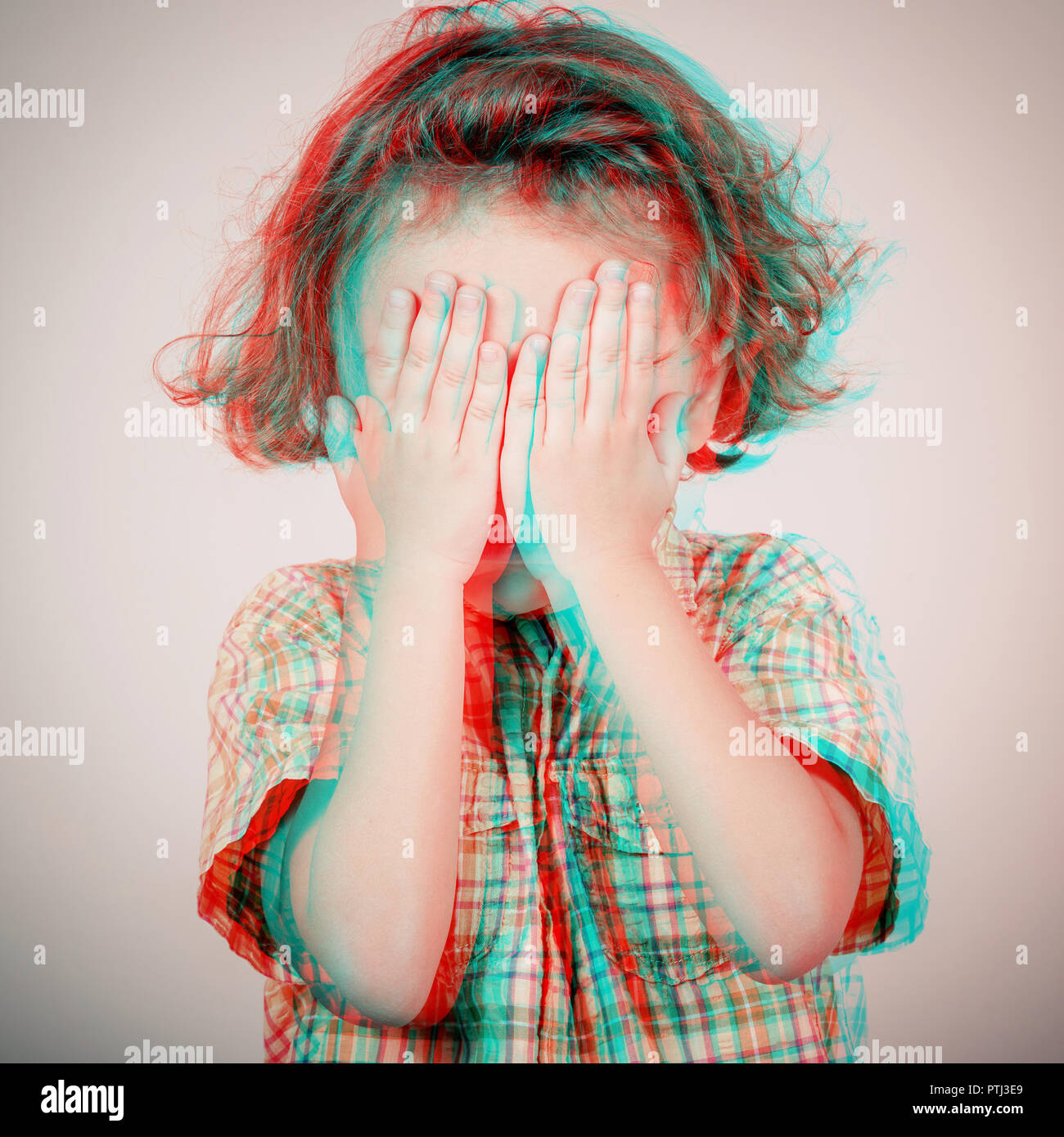 Portrait of a one sad little boy standing outdoors near the house at ...