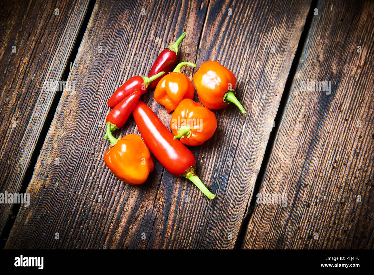 Group of Red fresh chilli on old rustic wood desk. Food background ...