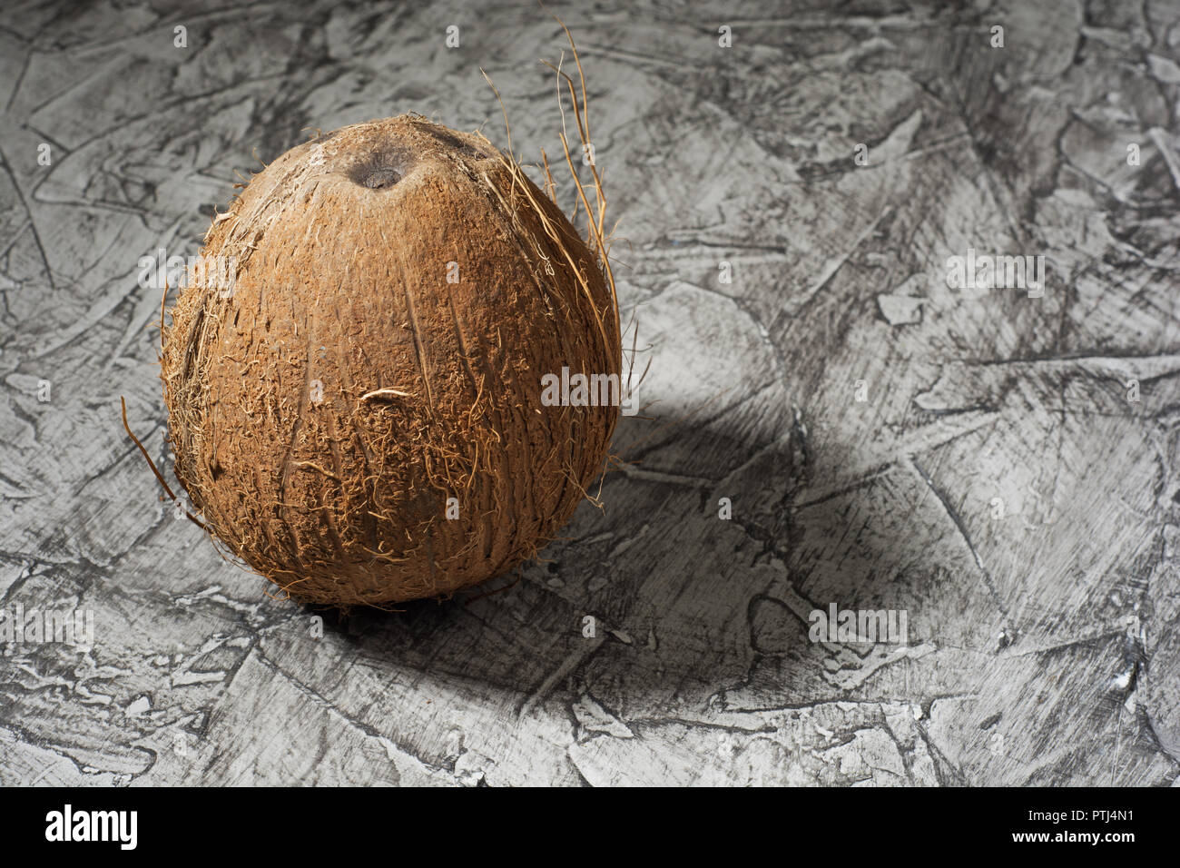 Whole coconut on old gray concrete background. Copy space Stock Photo ...