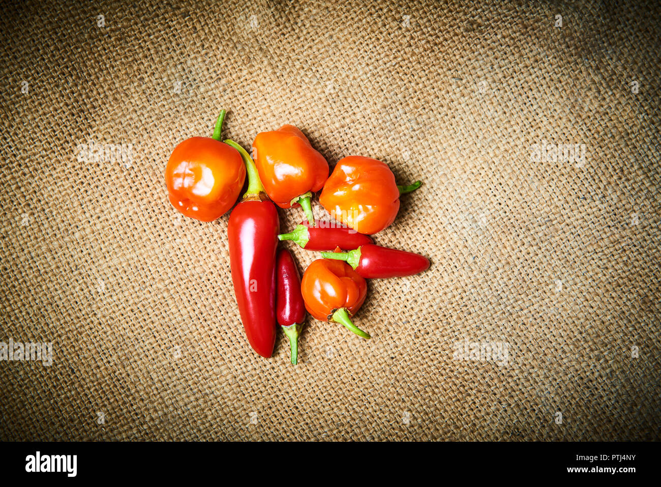 Group of Red fresh chilli on old sack cloth. Food background. Cooking ...