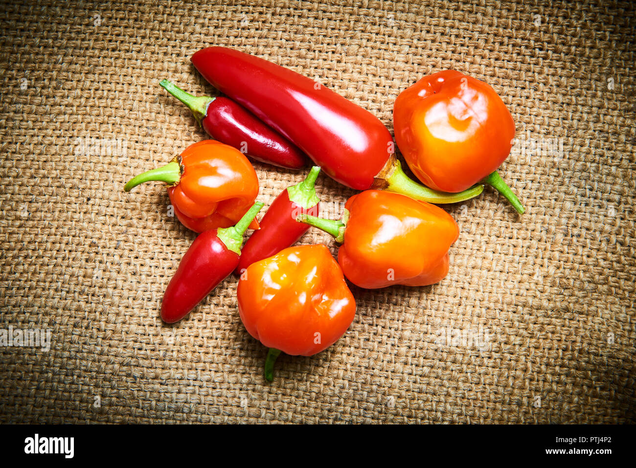 Group of Red fresh chilli on old sack cloth. Food background. Cooking ...