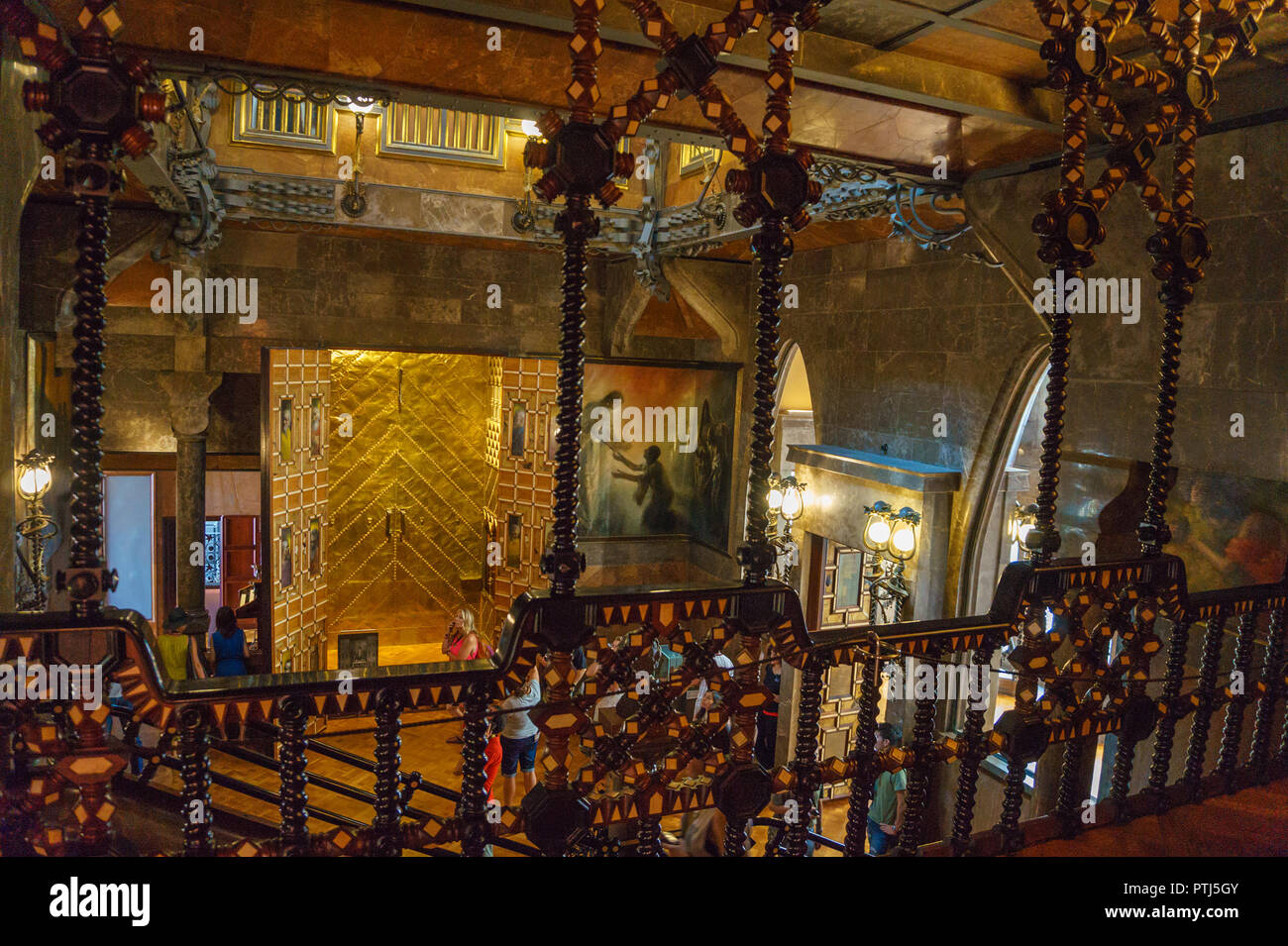 Tourists and visitors walk inside the Palau Guell palace designed by ...