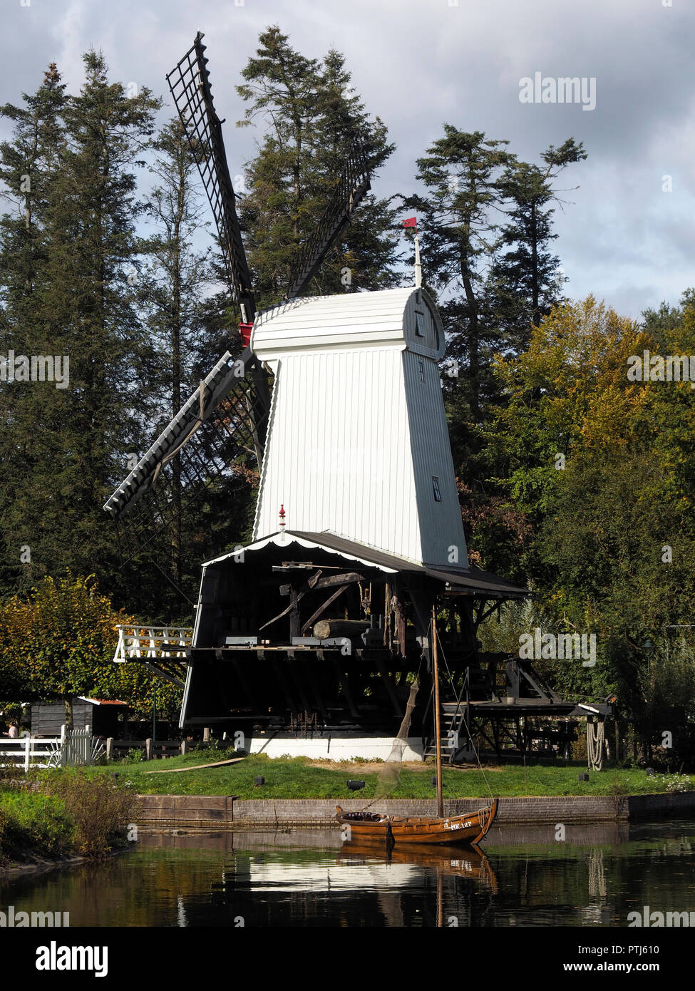 Old Dutch windmill that is driving a band saw to make planks from trees ...