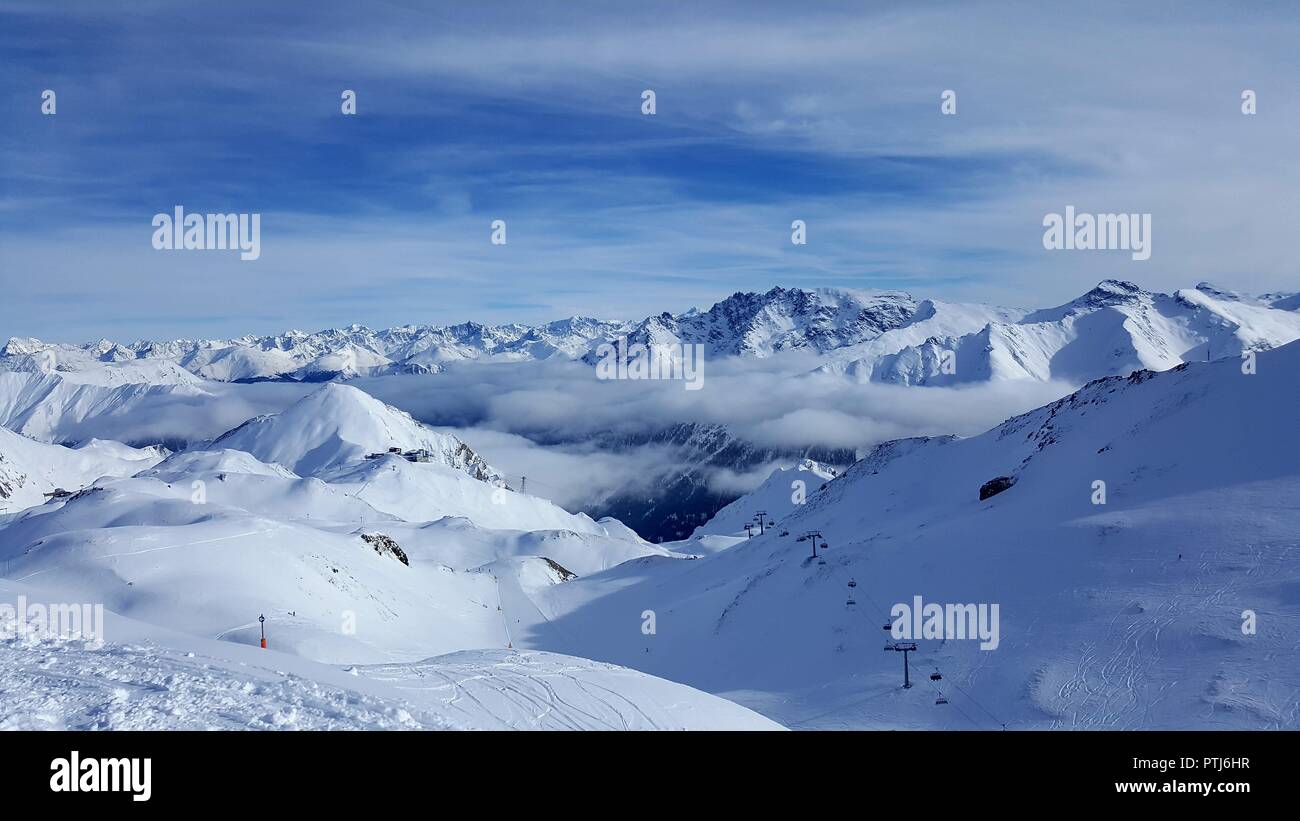 Image of ski resort with slopes in the mountains with low stratus over ...