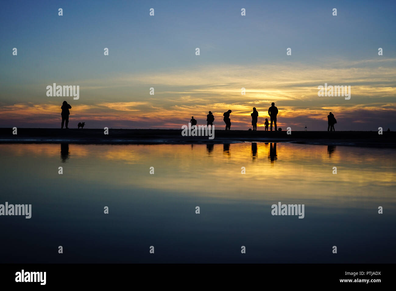 Human figures on a beach in San Francisco Stock Photo - Alamy