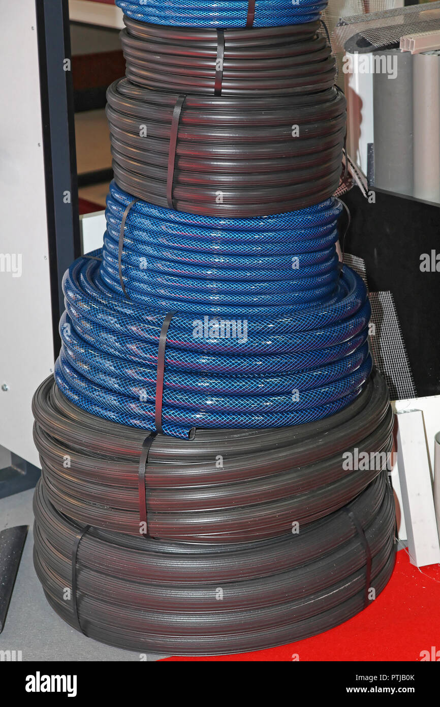 New Rubber Garden Hoses in Coils Stack Stock Photo - Alamy