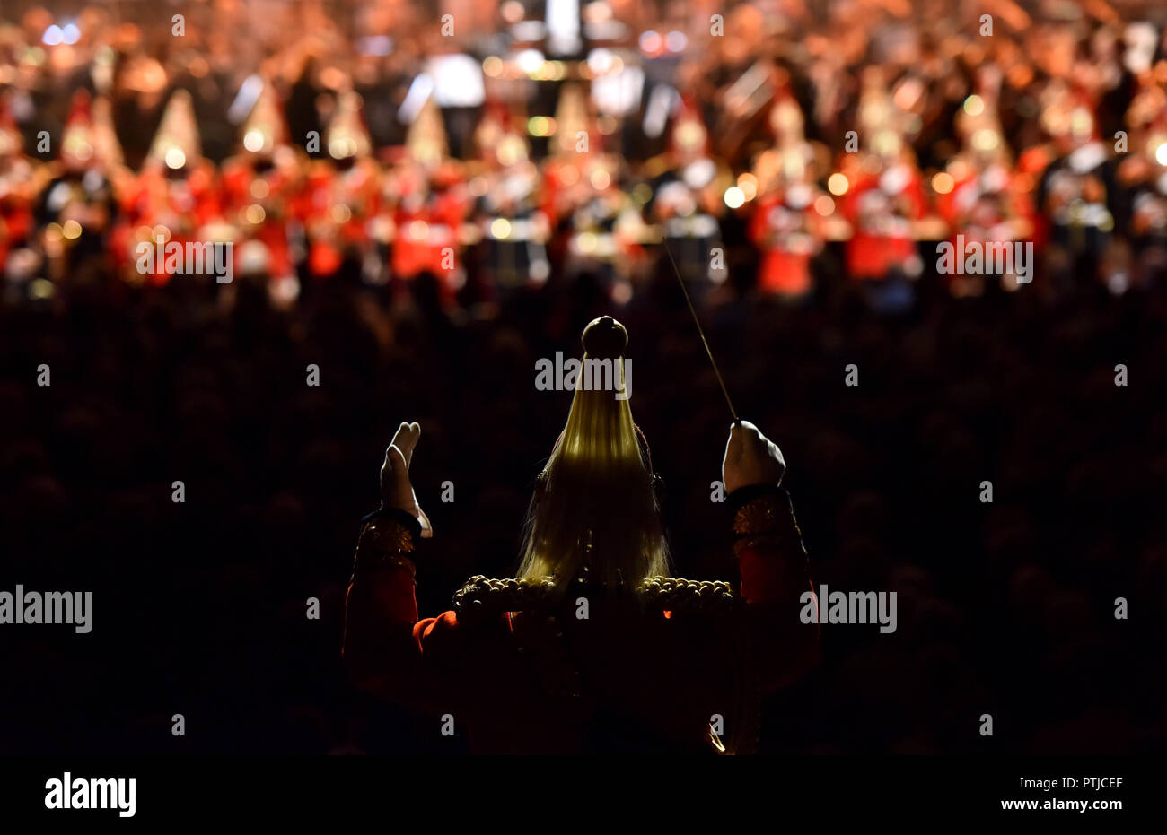 A Military Conducter conducts from a rostrum as Patrick Hawes conducts ...