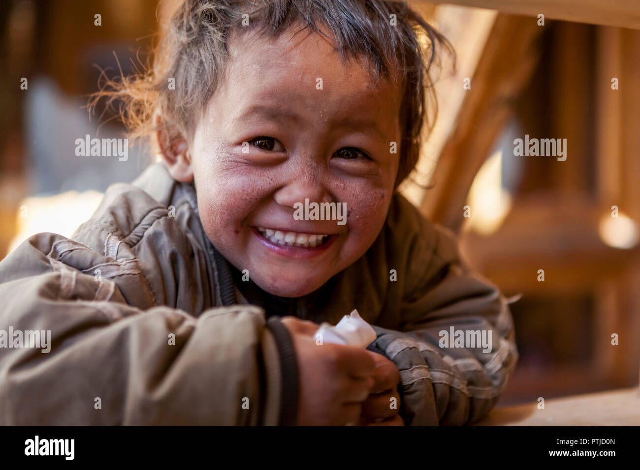 A girl smiling at the camera whilst playing in Nyawai in Nepal Stock ...