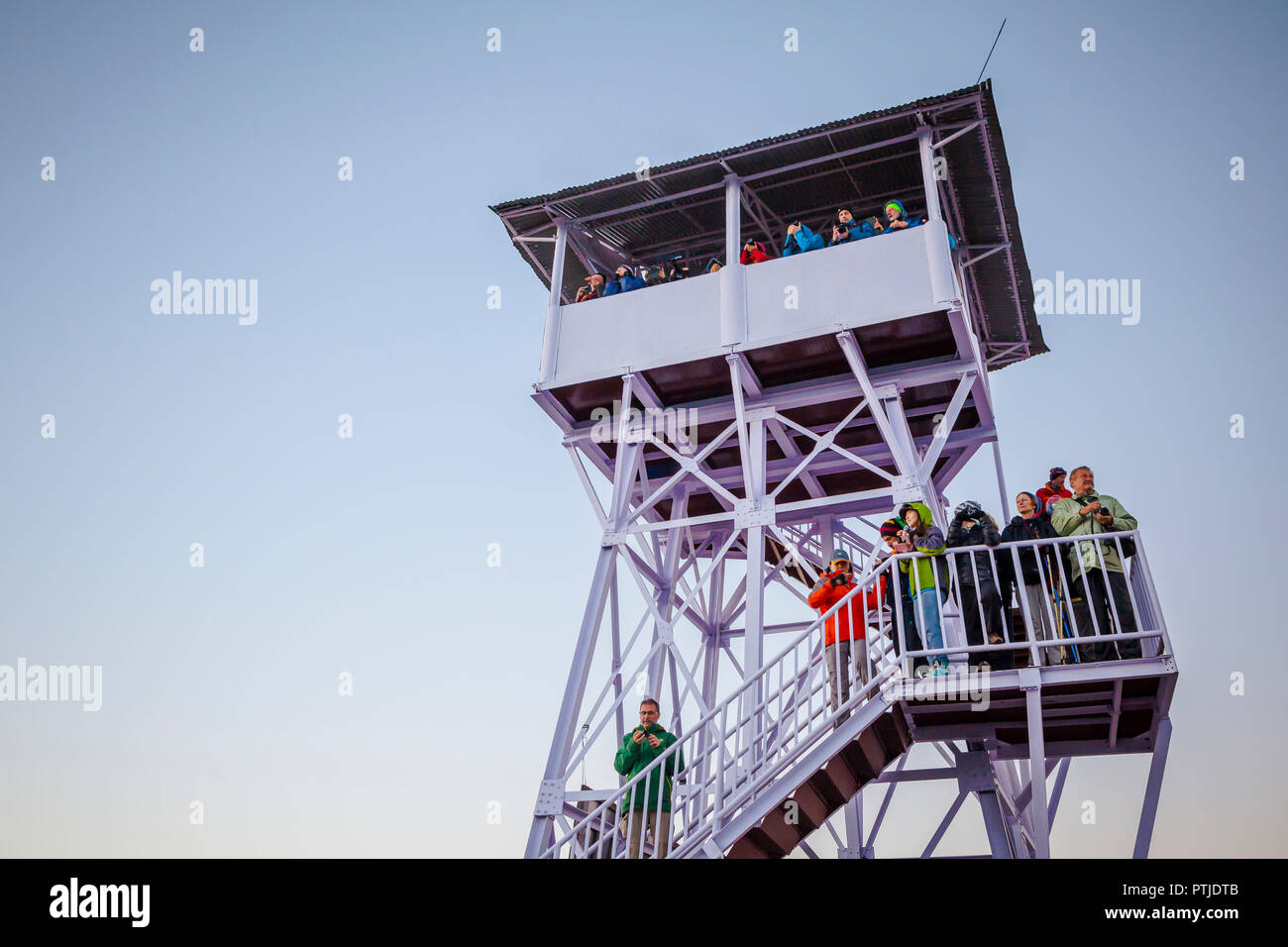Tourists capturing sunrise in the observation tower at Poon Hill in ...