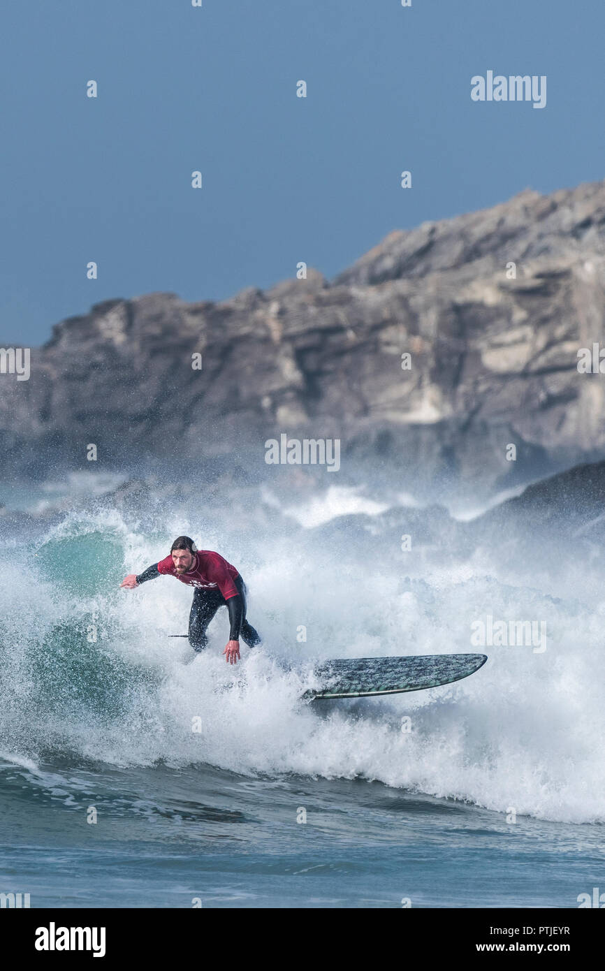 A surfer competing in a longboard competition at Fistral Beach in ...