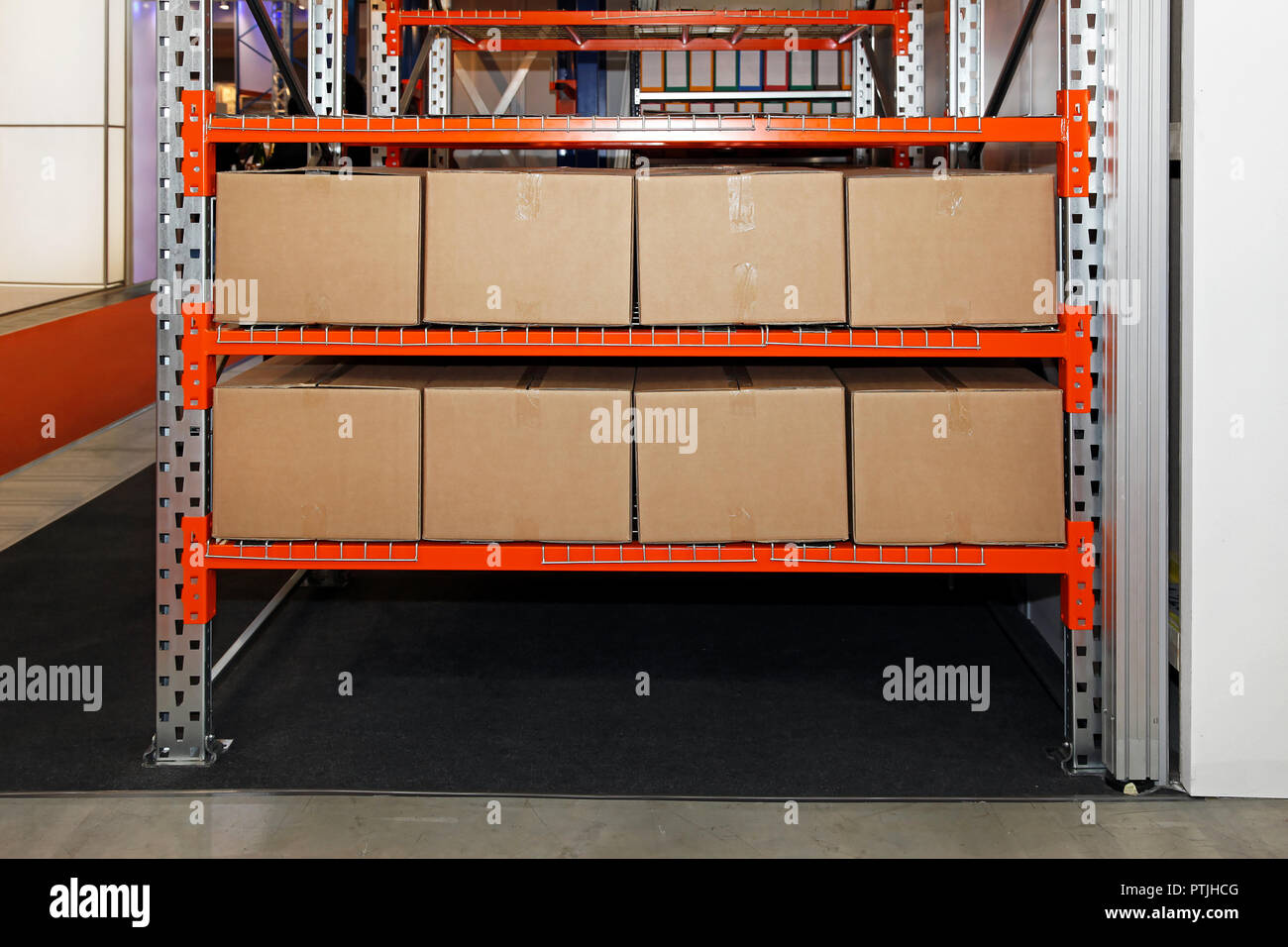Postal cardboxes at shelf in distribution warehouse Stock Photo - Alamy