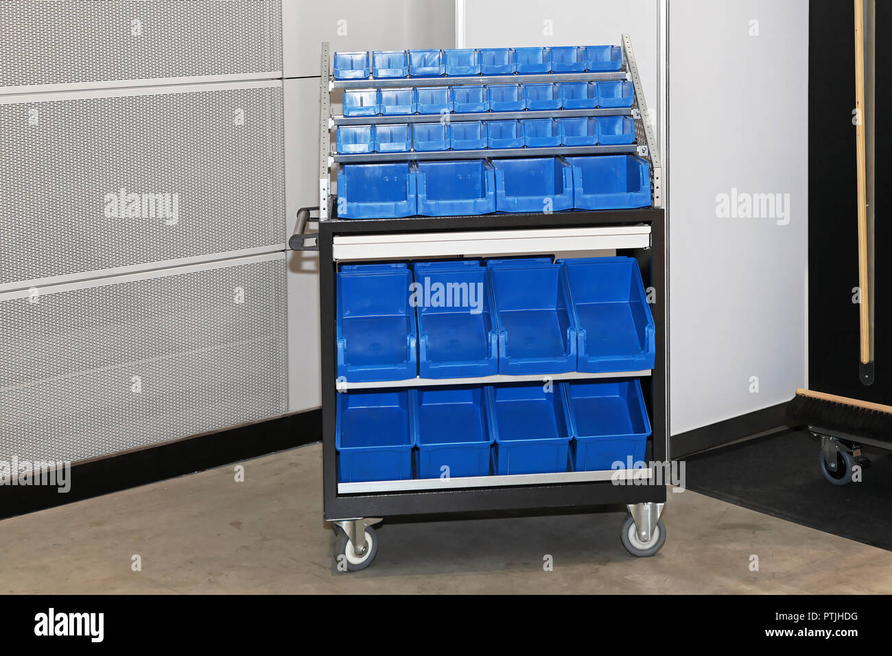 Sorting cart with blue bins in garage workshop Stock Photo - Alamy